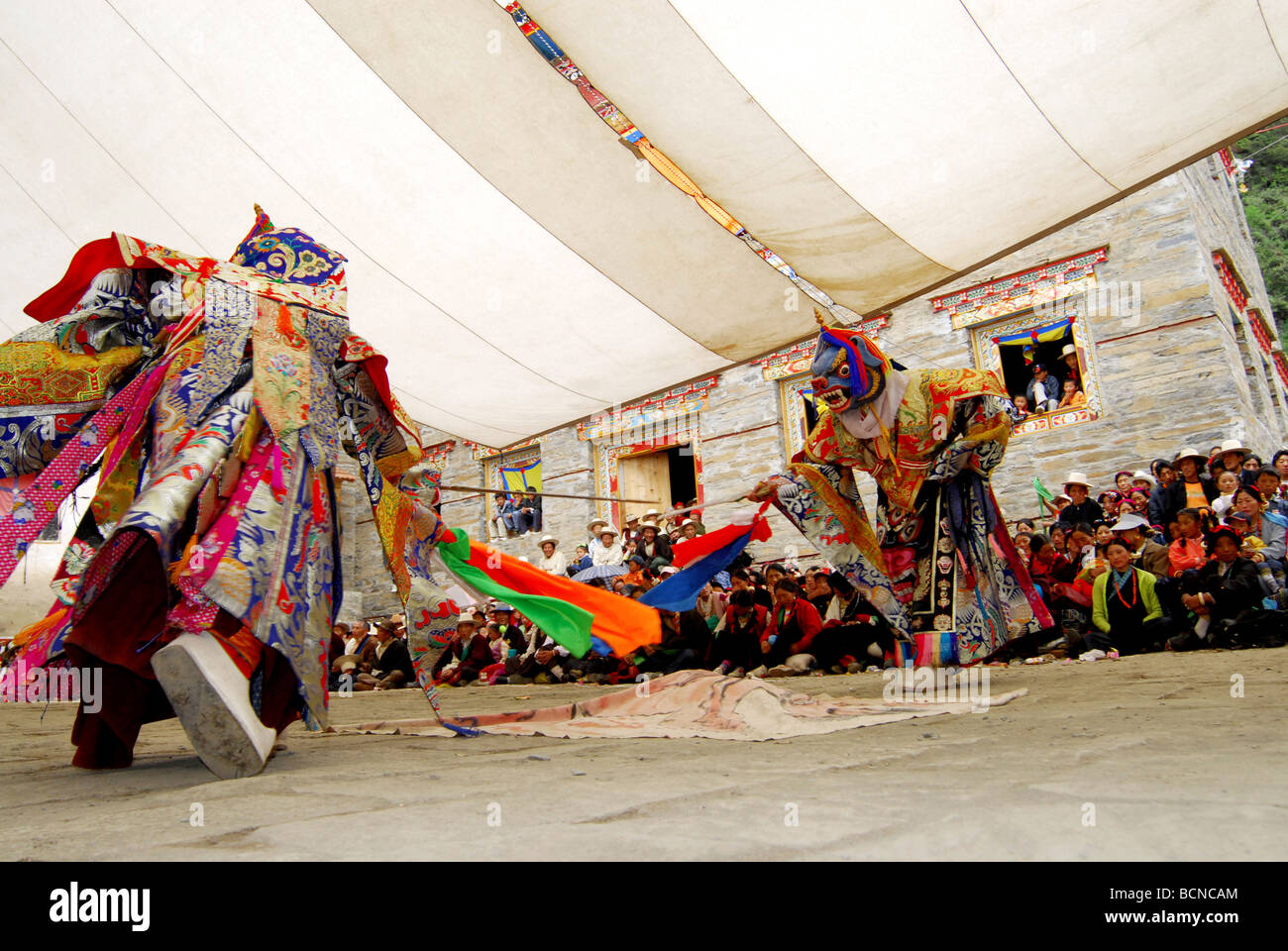 Lamas in elaborate costume and mask performing religious ritual dance ...