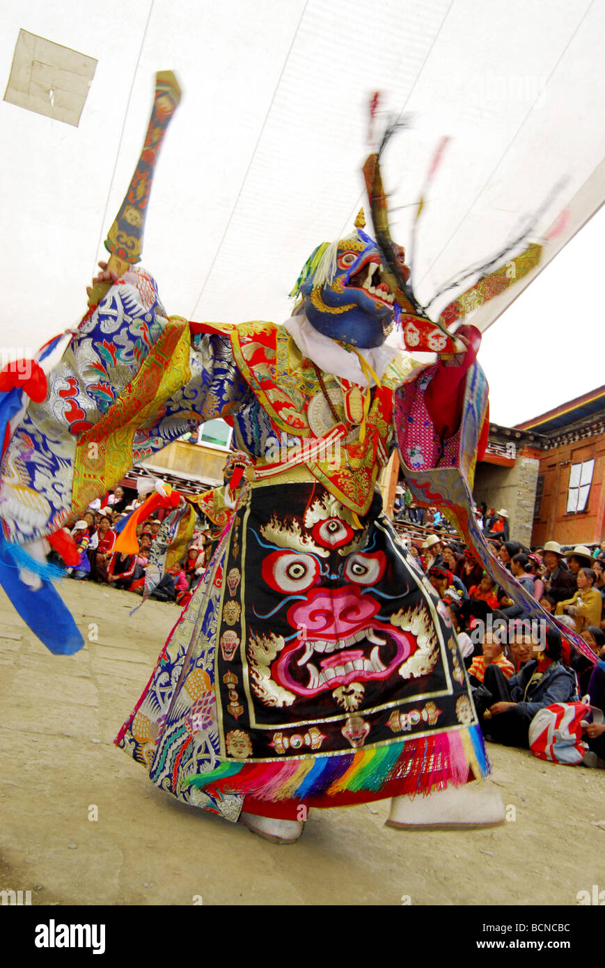 Lama in elaborate costume and mask performing religious ritual dance ...