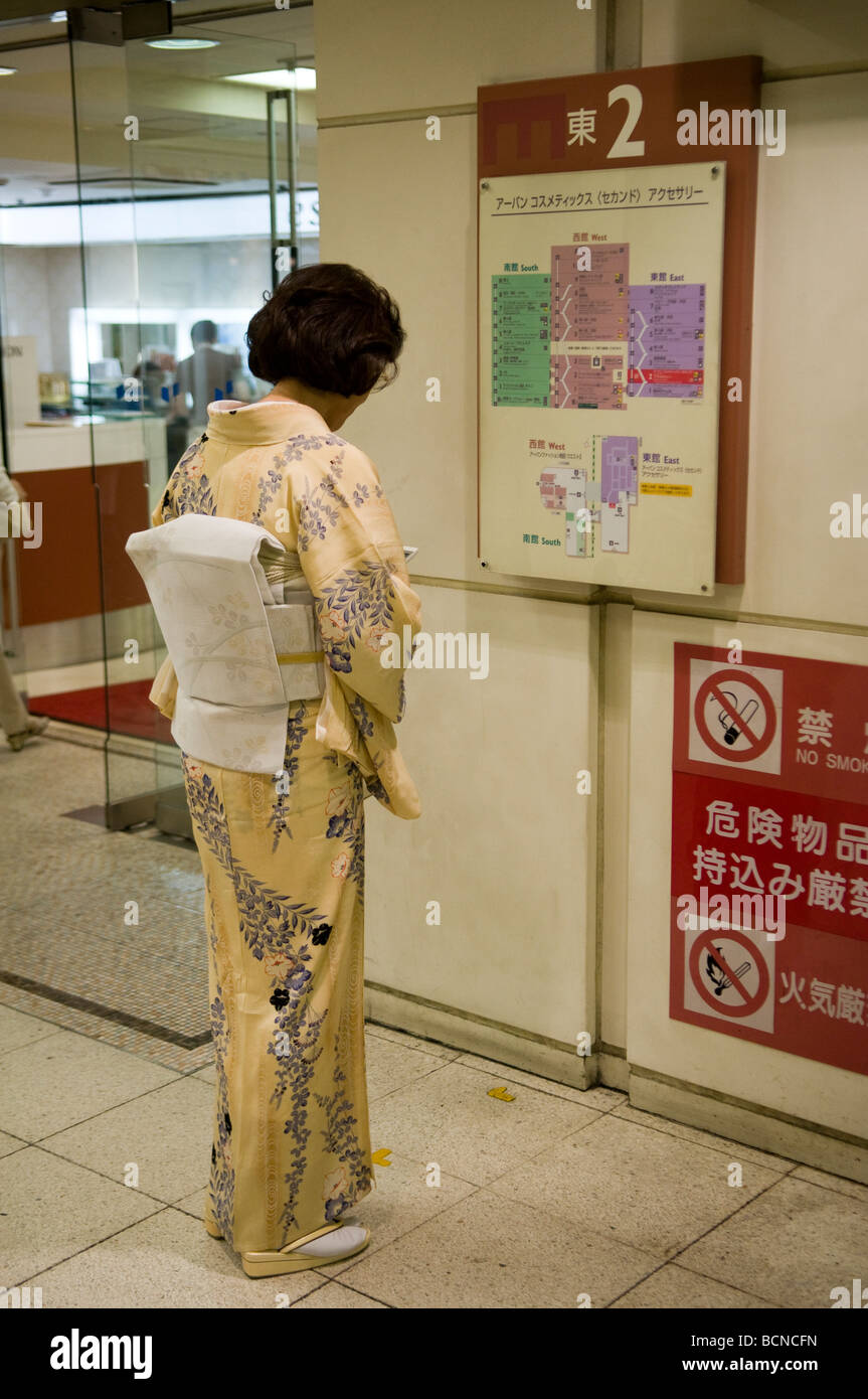 A woman in traditional Kimono garment in a subway metro in Tokyo Japan ...