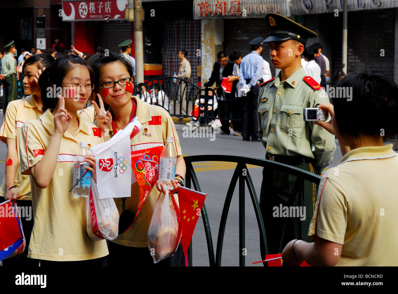 School girls posing for photograph beside the torch relay route ...