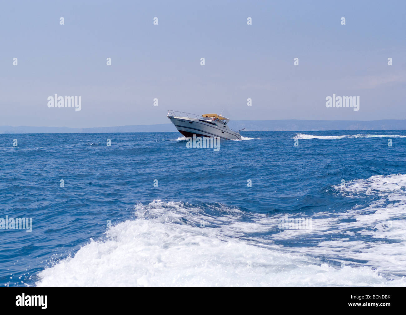 Motor Cruiser or Speedboat Passing Boat Wake in Mediterranean Sea near ...
