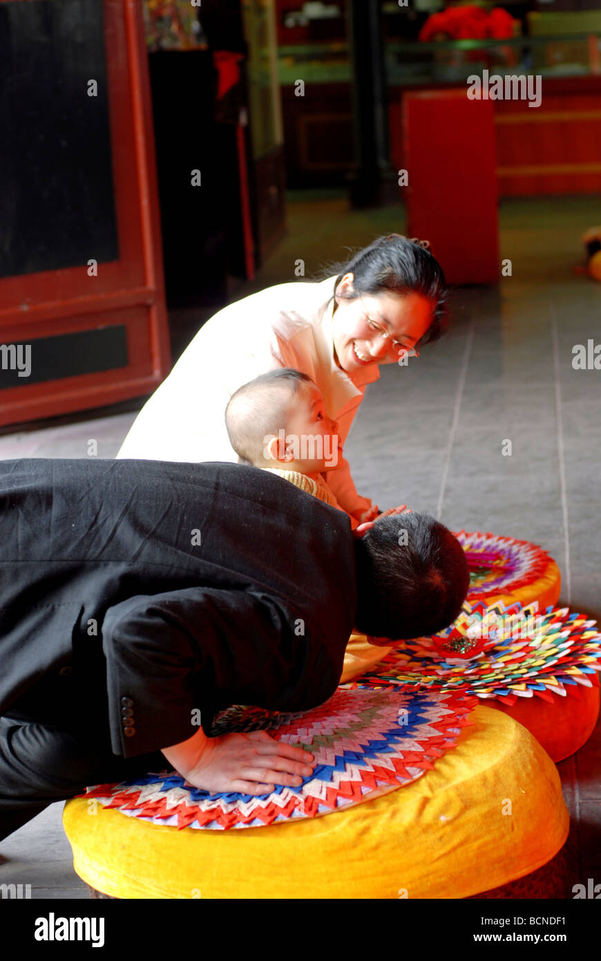 A family of three praying before Taoist deity Lu Dongbing, Qingyang ...