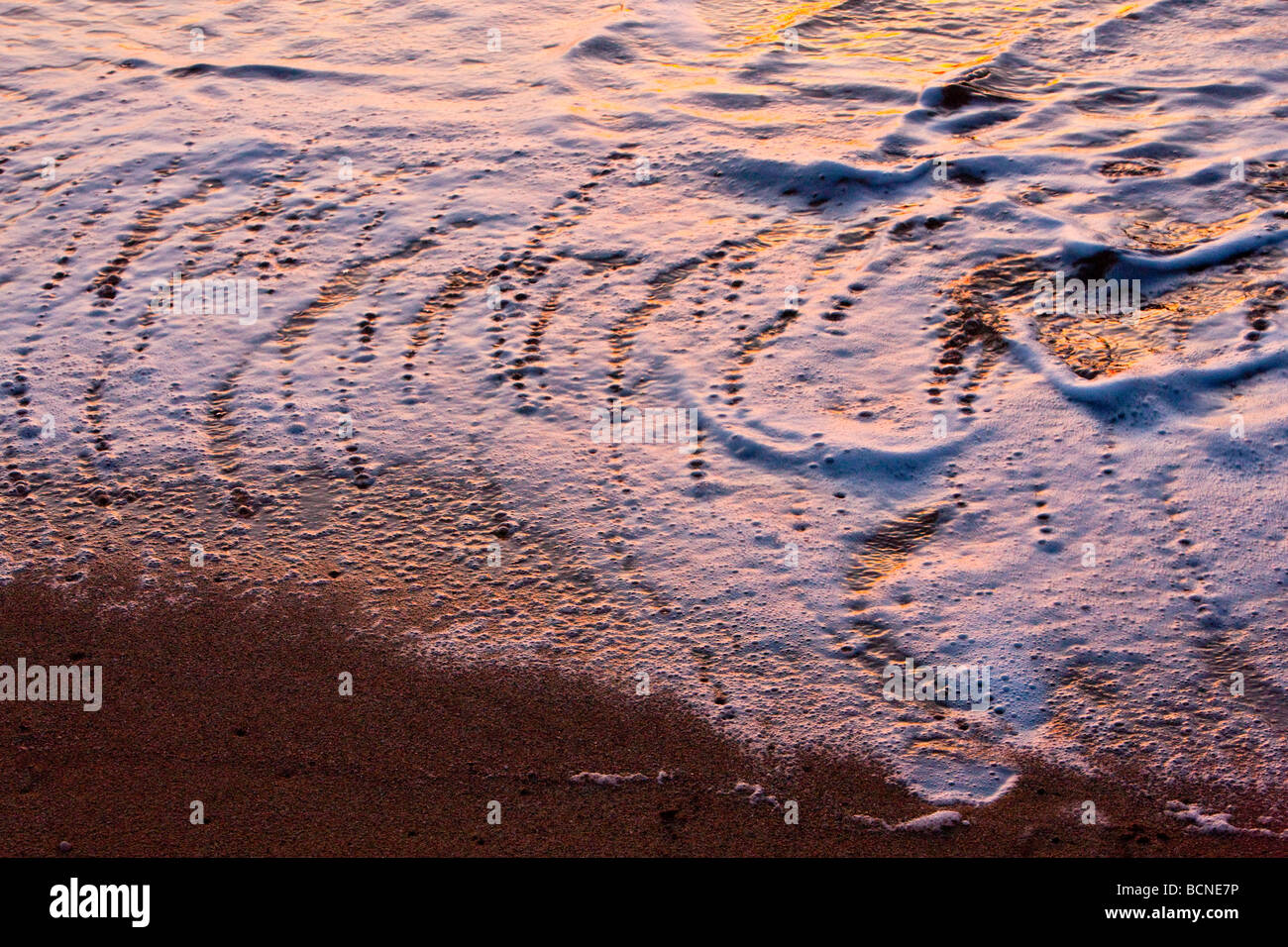 Patterns in sea foam on sandy beach Isle of Lewis Scotland Stock Photo ...