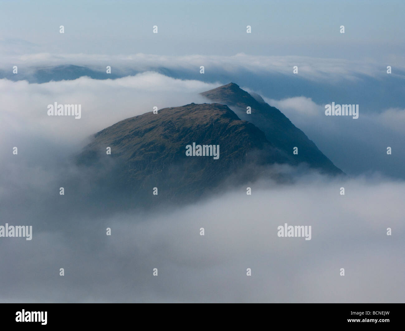 Yewbarrow summit rises above mist Stock Photo - Alamy