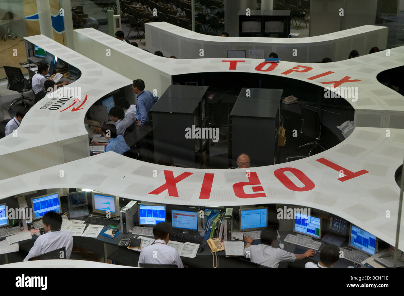 Traders at the Tokyo Stock Exchange watch computer screens during the ...