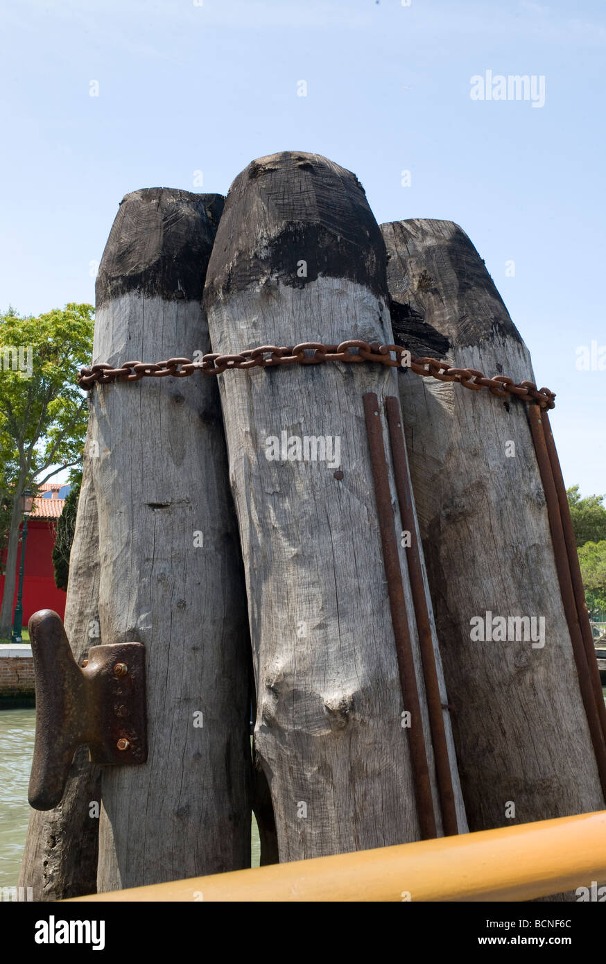 Wooden mooring posts Stock Photo - Alamy