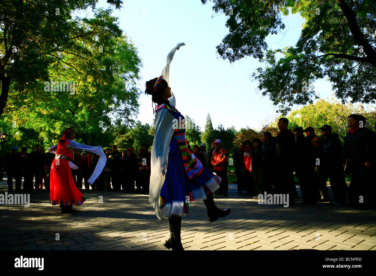 Two Chinese women in Tibetan ethnic clothing dancing, Beihai Park ...