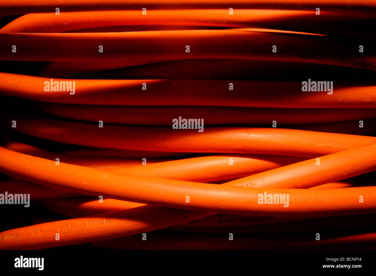 Orange extension cord - cable Stock Photo - Alamy