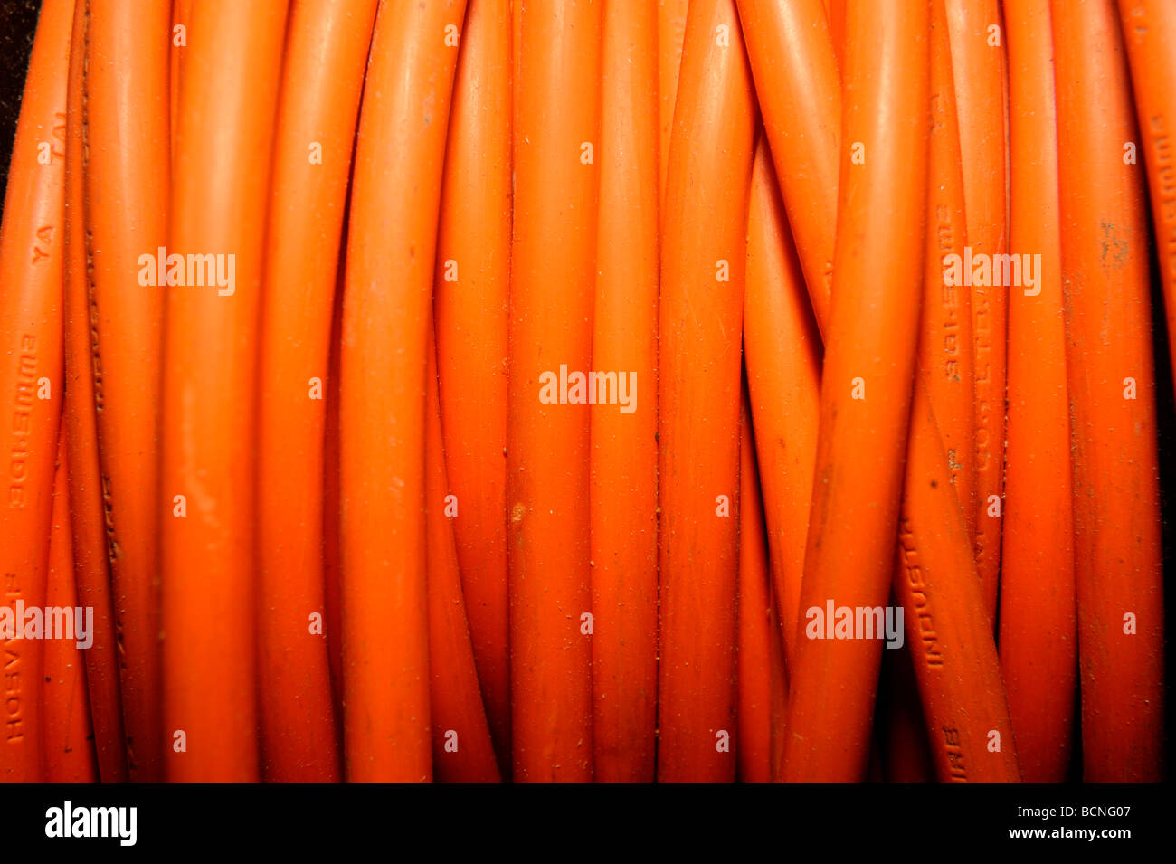 Orange extension cord - cable Stock Photo - Alamy