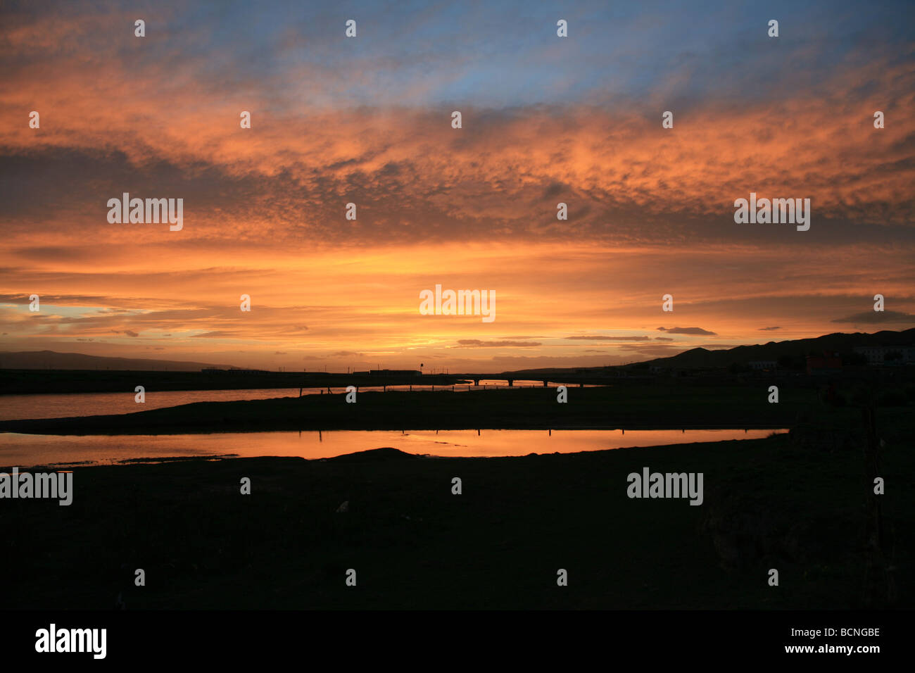 Sunset over Qinghai Lake where fences built to protect the breeding ...