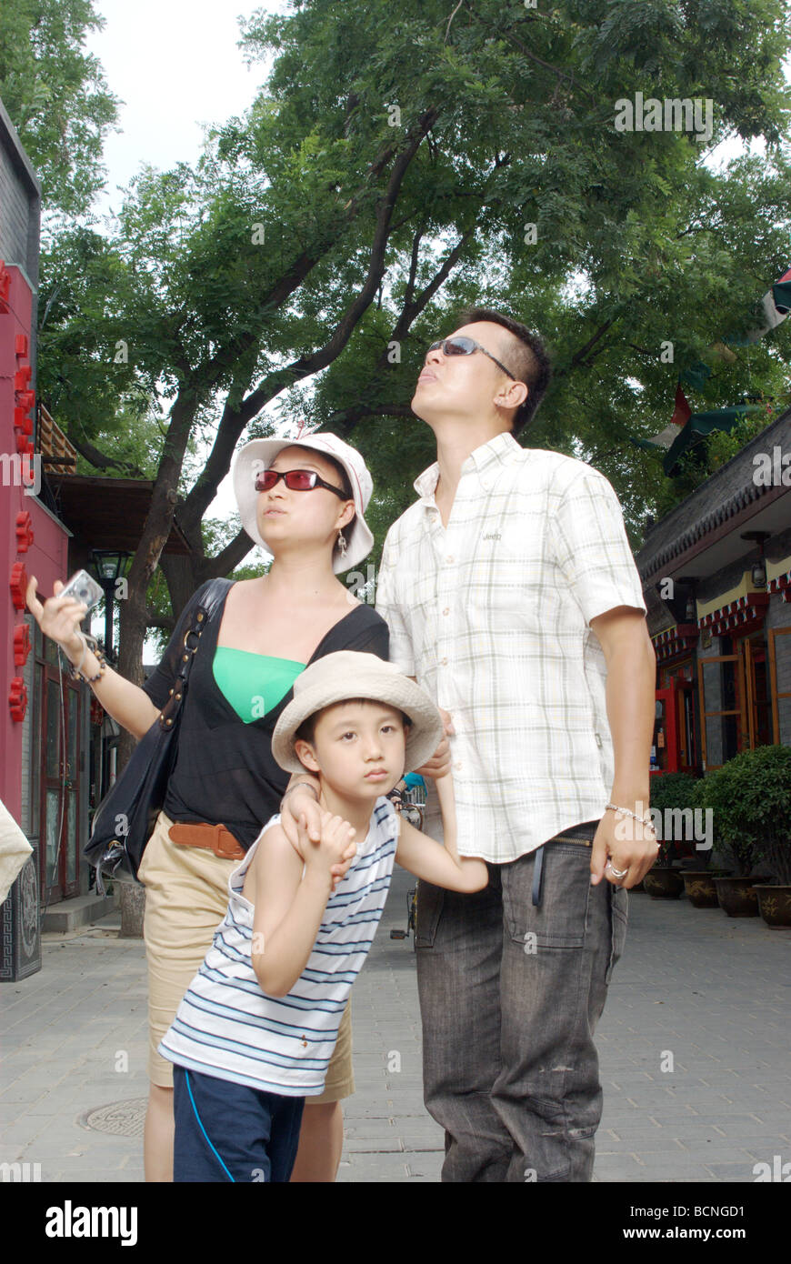 Chinese family touring Hutong in Houhai bar area, Beijing, China Stock ...