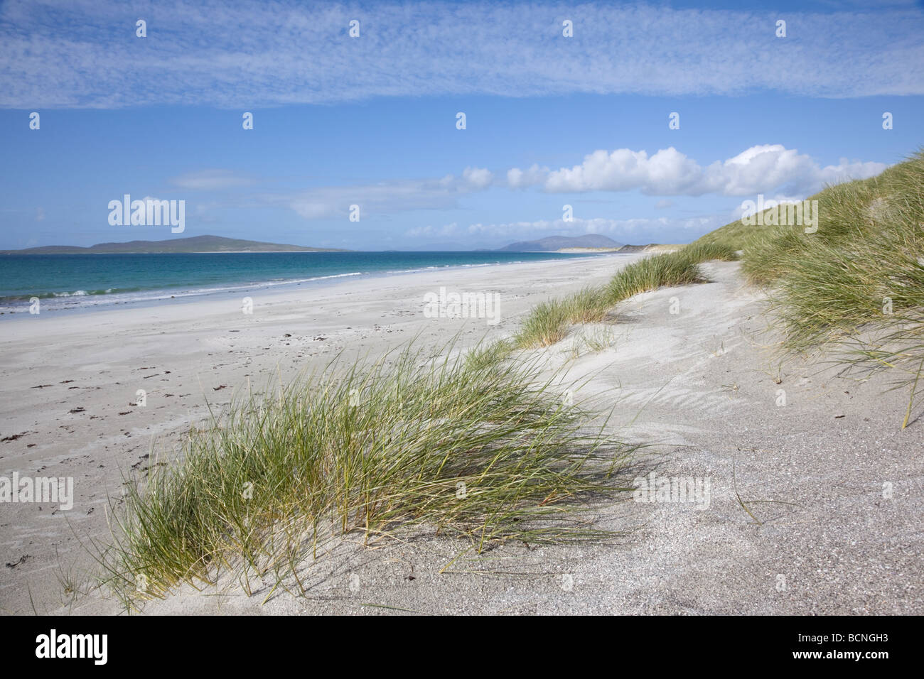 Shell sand on the west coast of Berneray with the island of Pabbay to ...