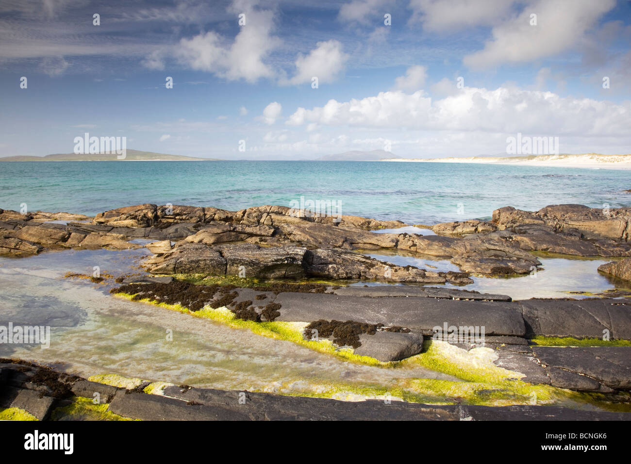 Rocky headland on the western shore of the island of Berneray with ...