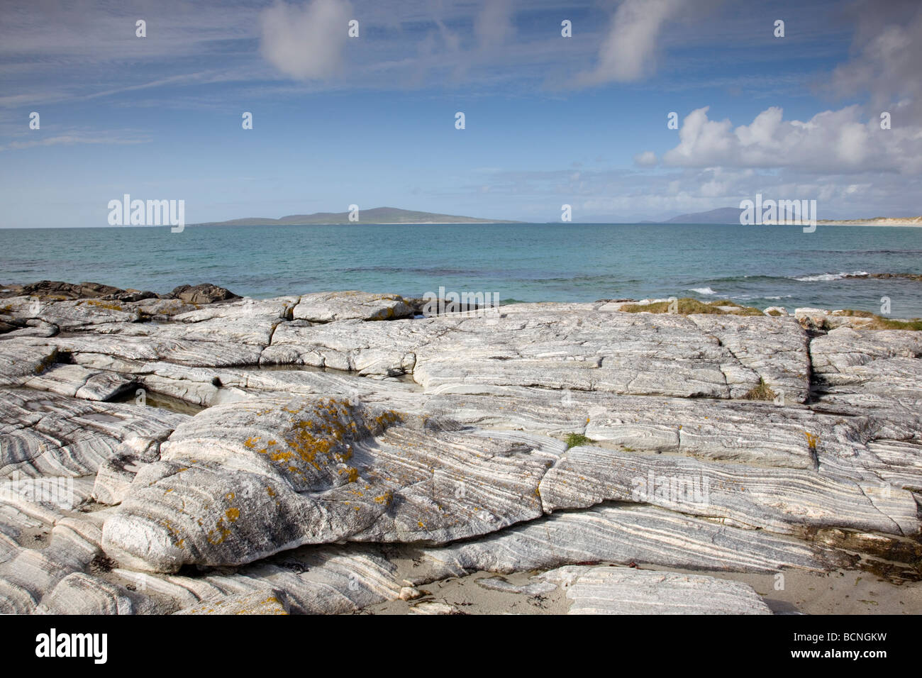 Rocky headland on the western shore of the island of Berneray with ...