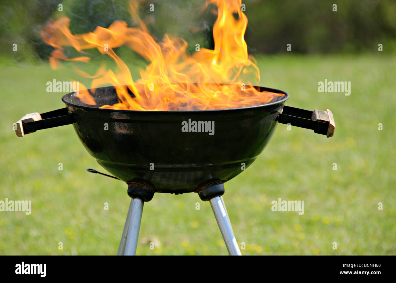 BBQ starting fire with flame, standing alone outdoor Stock Photo - Alamy