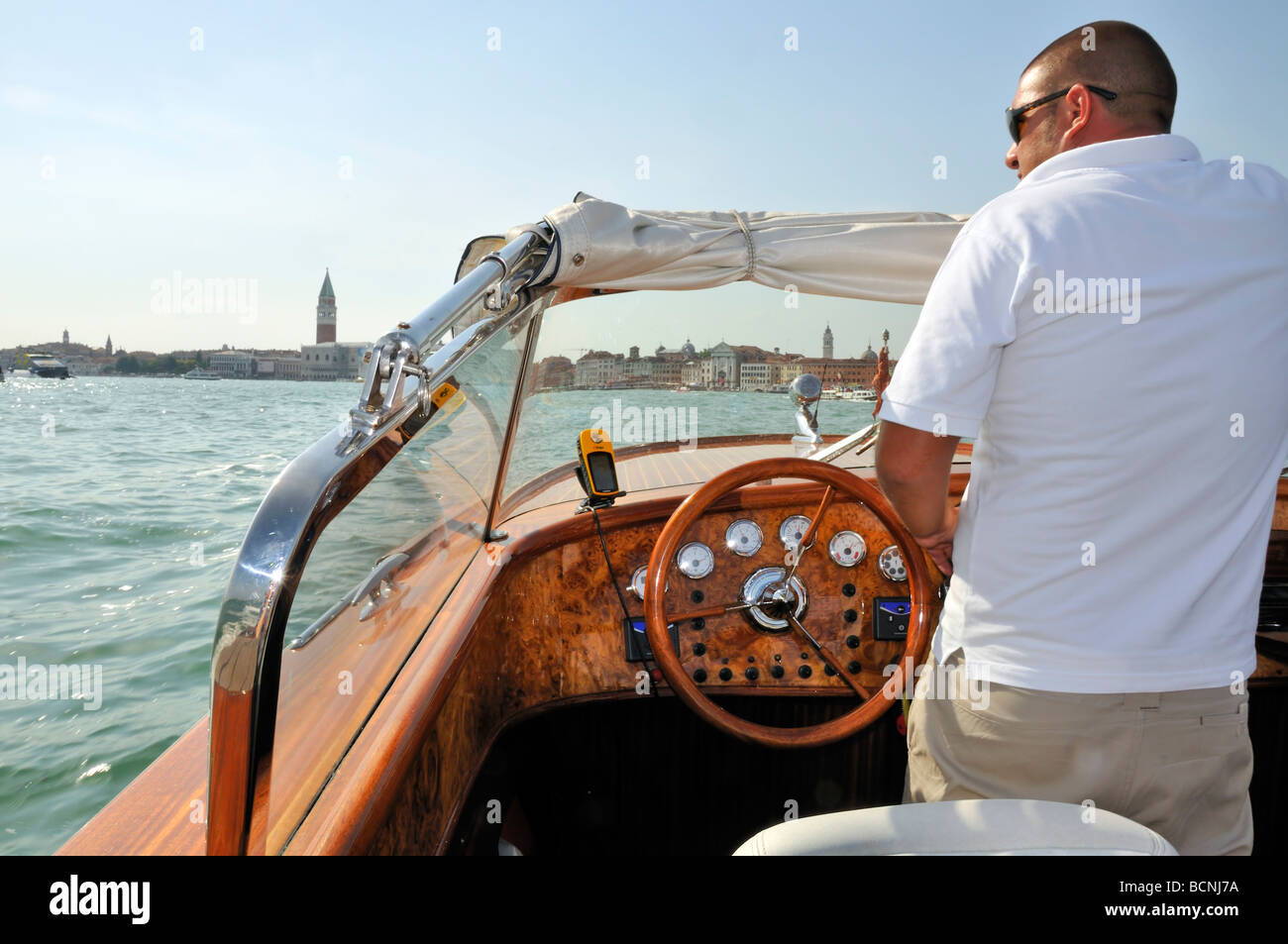 Italian man navigating in the sea, Venice, Italy Stock Photo - Alamy