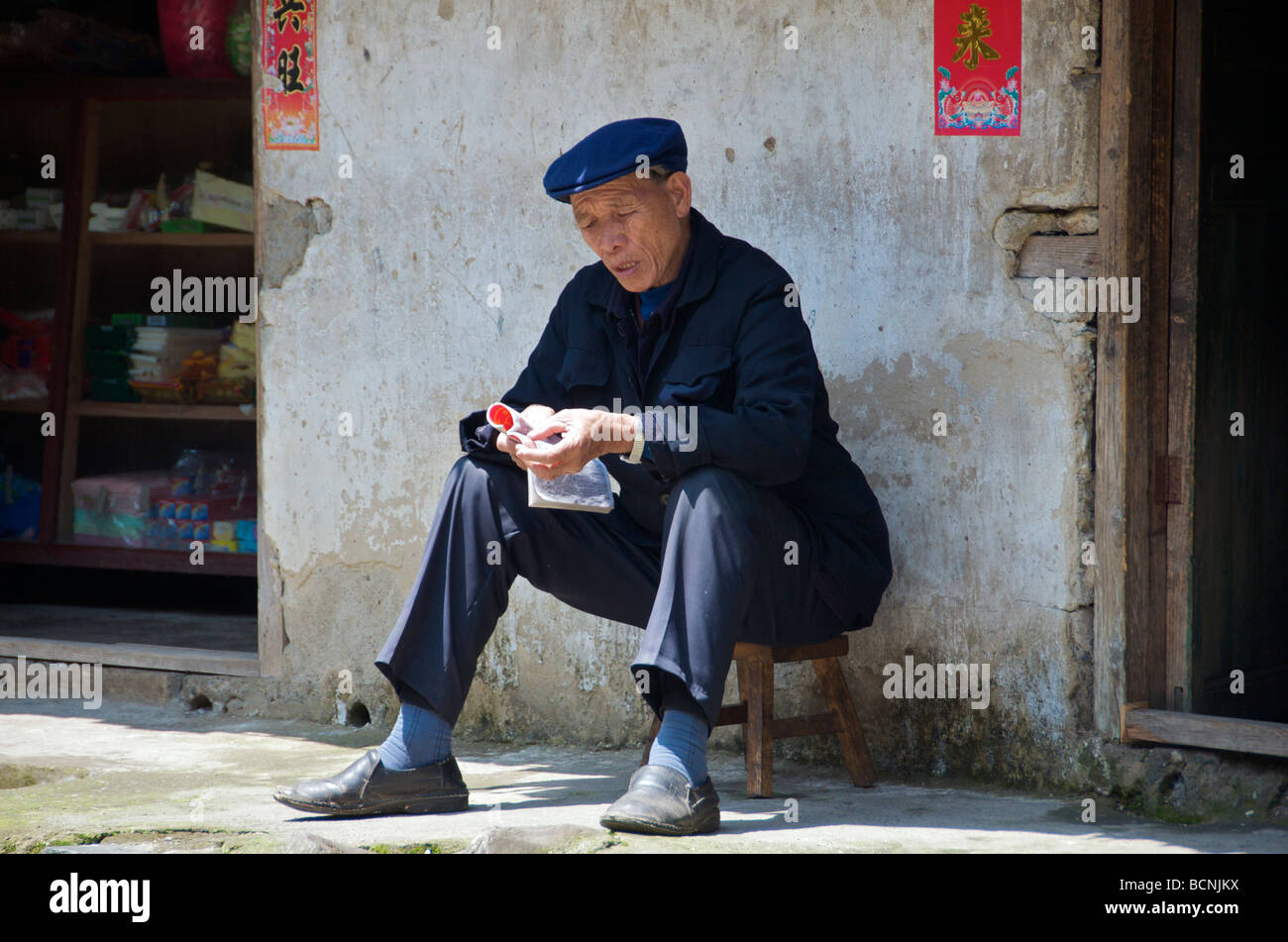 Yao man reading minority tribe Village Guangxi China Stock Photo - Alamy