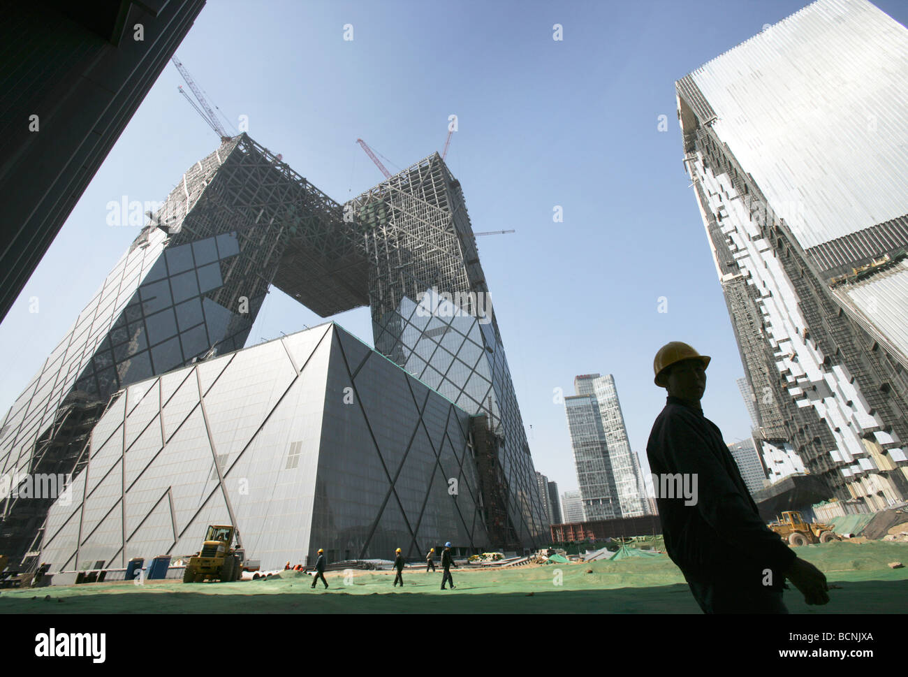 Construction worker walking pass the CCTV Tower still under ...