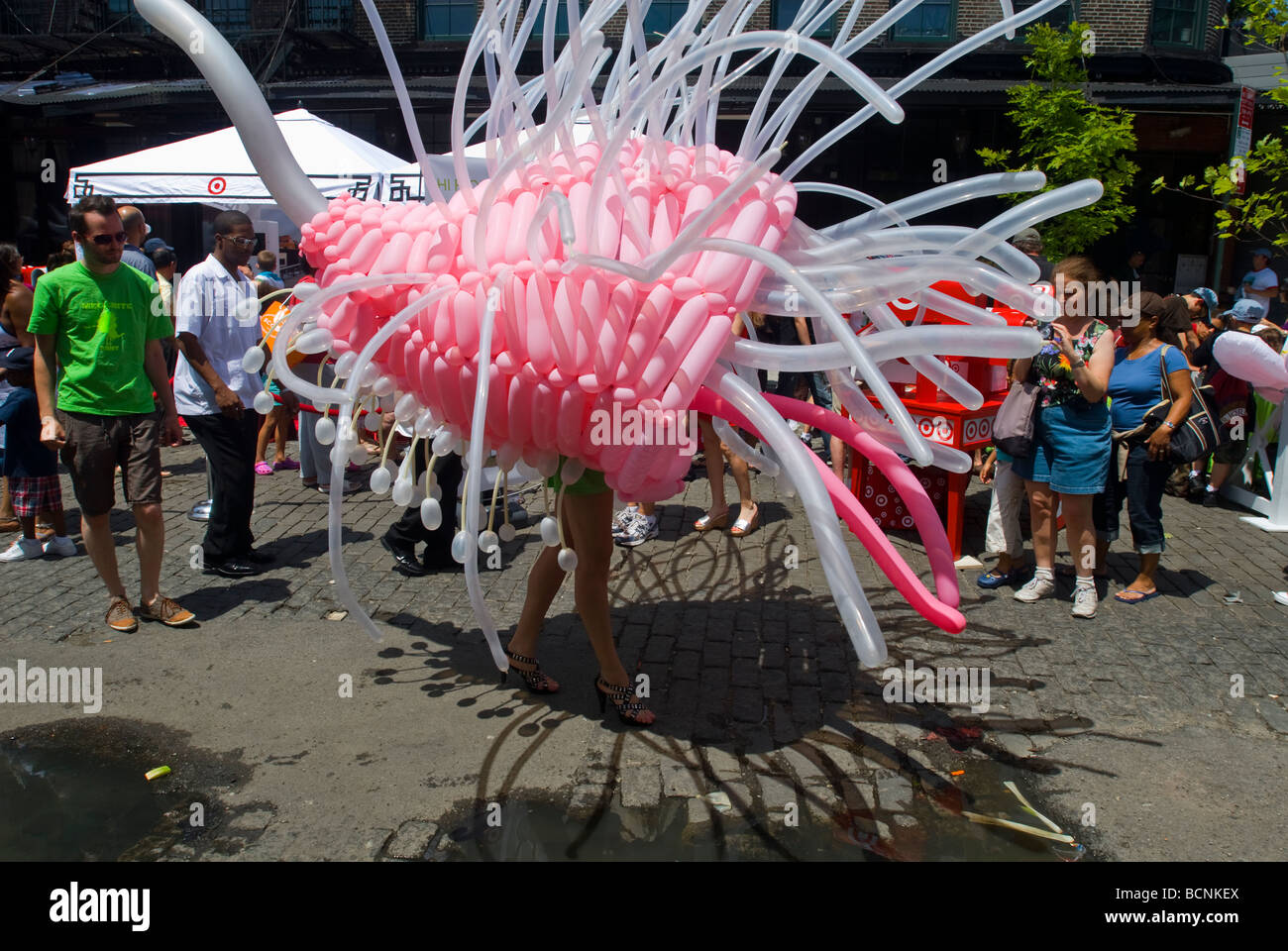 A performer wears a balloon costume by the artist Jason Hackenwerth in ...