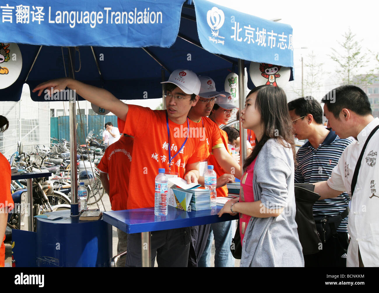 Volunteers giving directions to event goers, Beijing, China Stock Photo ...