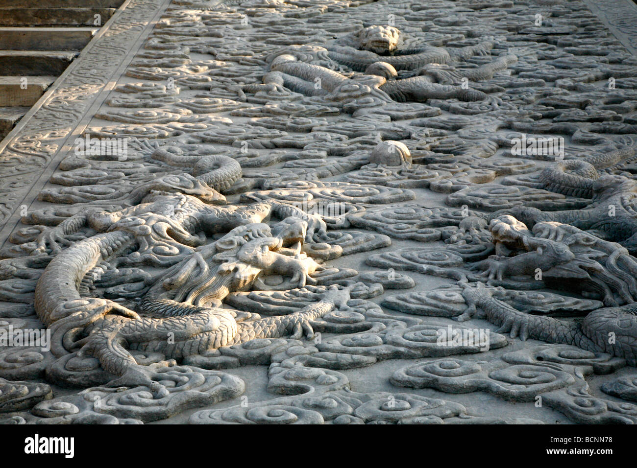 Detail of vivid dragon and cloud carving on the raised marble platform ...