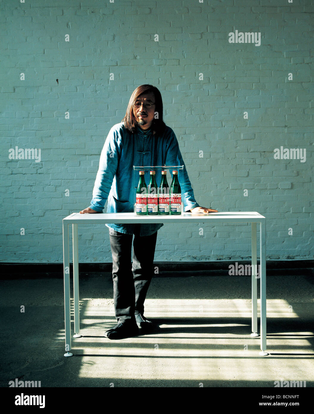Artist Huang Rui standing behind one of his sculpture using modern day ...