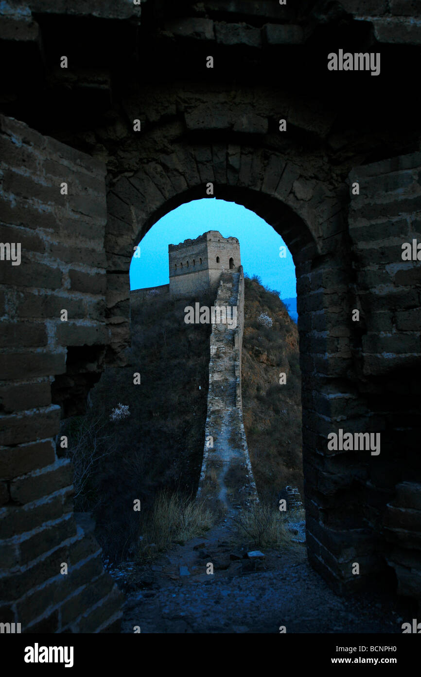 Damaged Great Wall through a gate of a beacon tower, Jinshanling Great ...