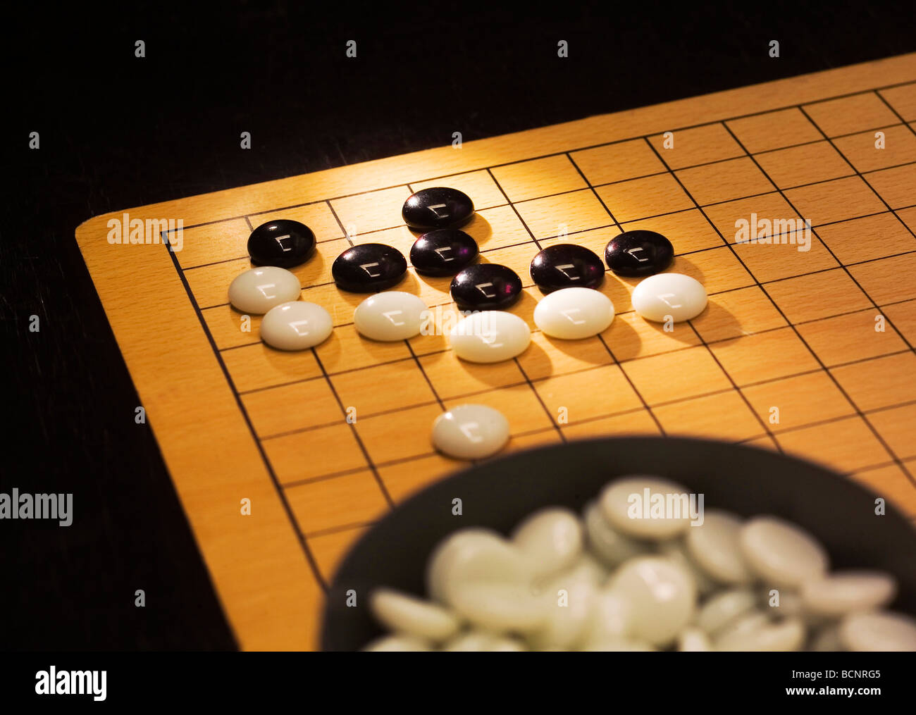Weiqi game board with game in session Stock Photo - Alamy