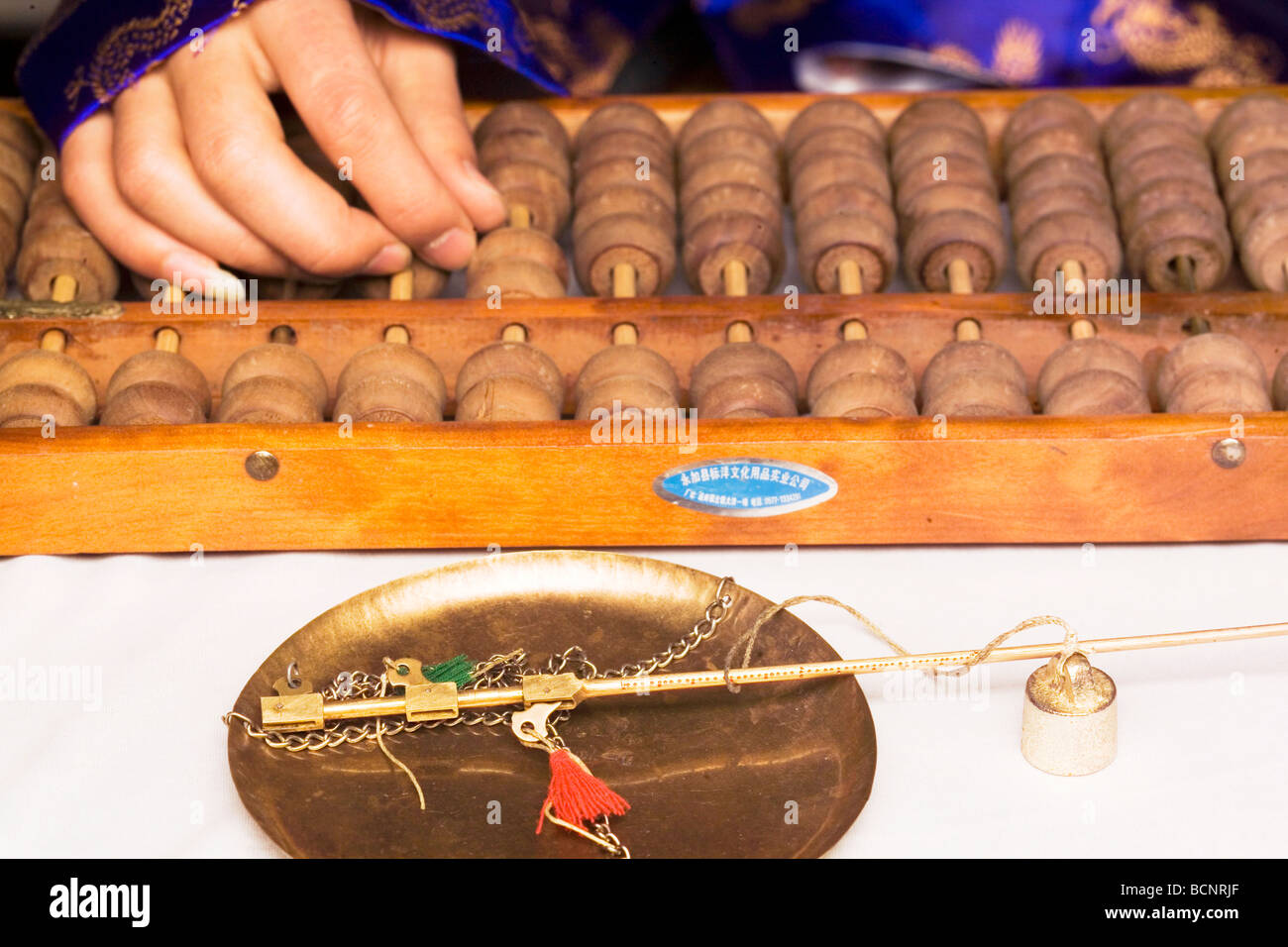 Man using Chinese traditional calculator abacus with weight scale on ...