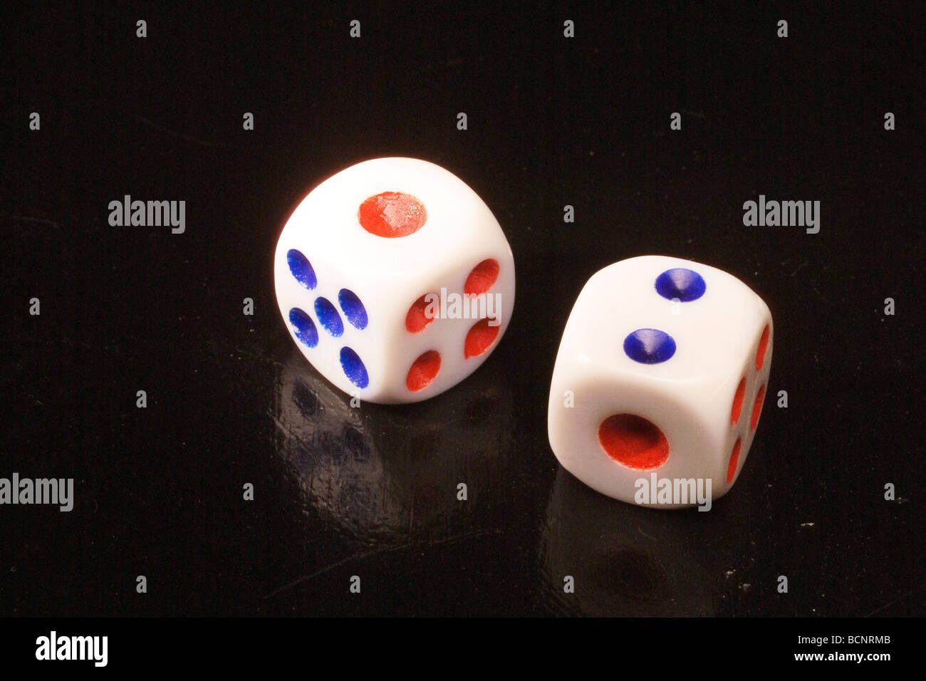 Two dices with black background Stock Photo - Alamy