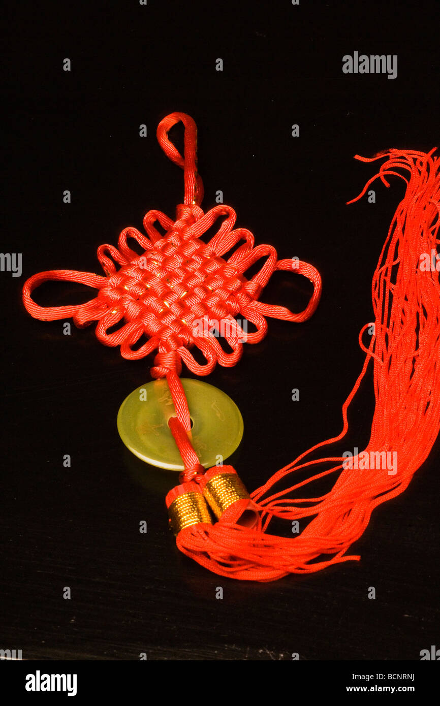 Chinese knot with jade piece Stock Photo - Alamy