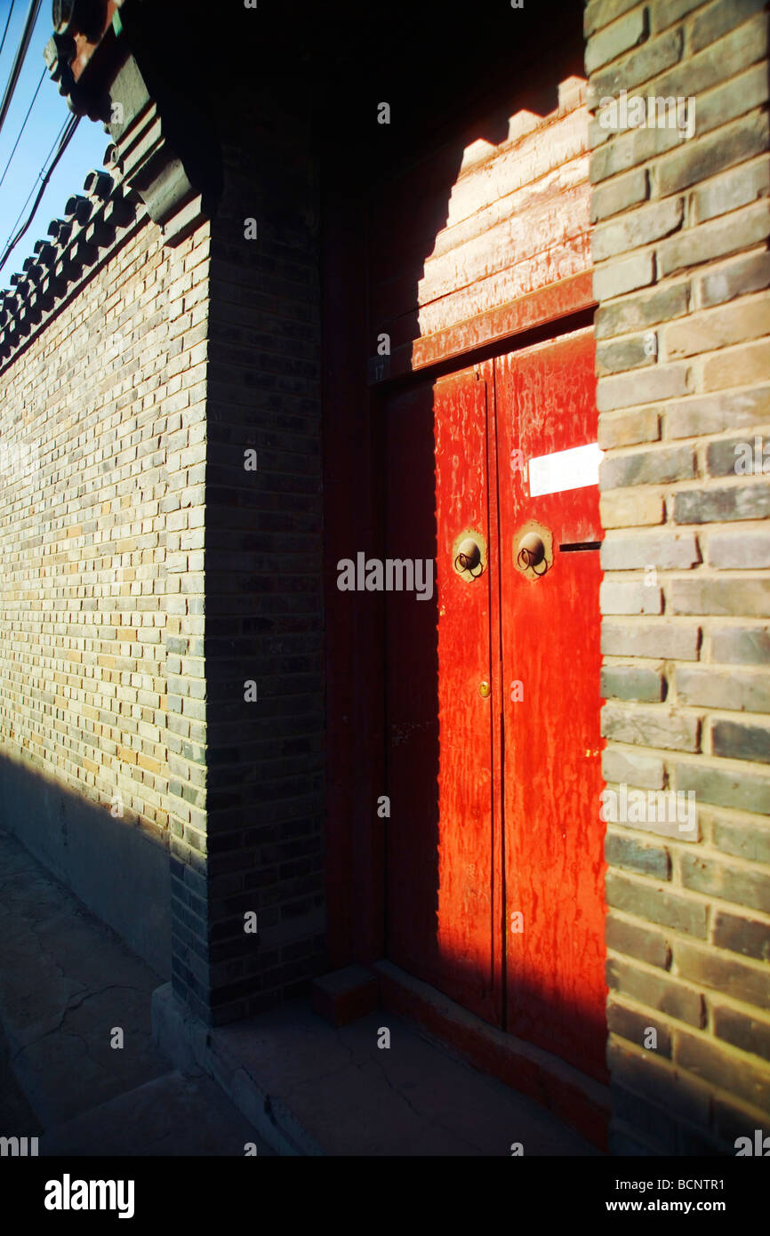 Red front gate of a courtyard house in a typical hutong, Beijing, China ...