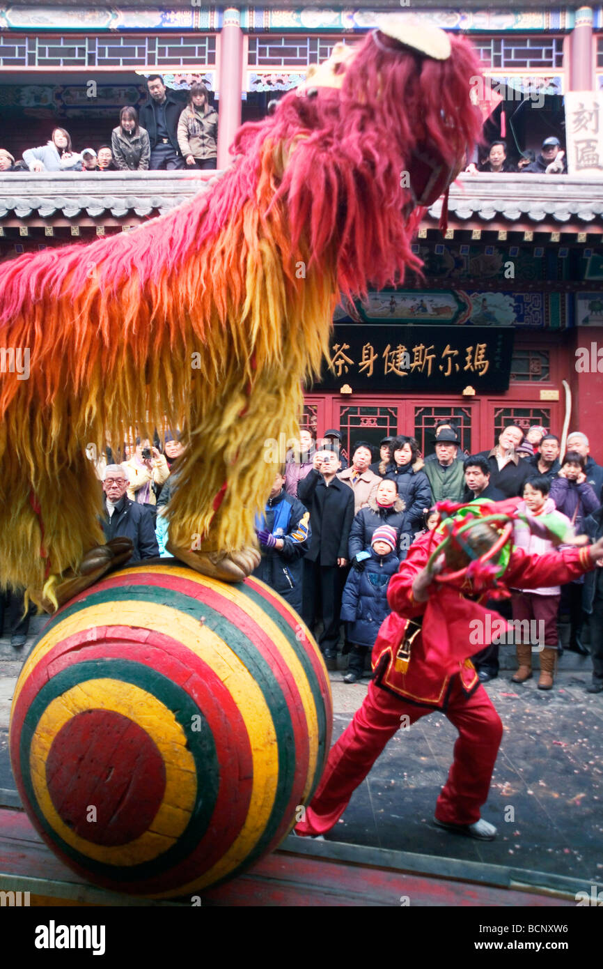 Lion dance actors performing on Gulou Street, Tianjing, China Stock ...