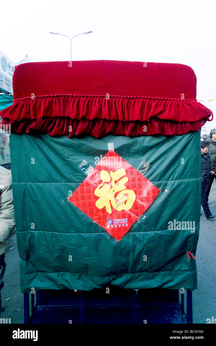 Big red "Fu" taped to the back of a rickshaw, Gulou Street, Tianjing ...