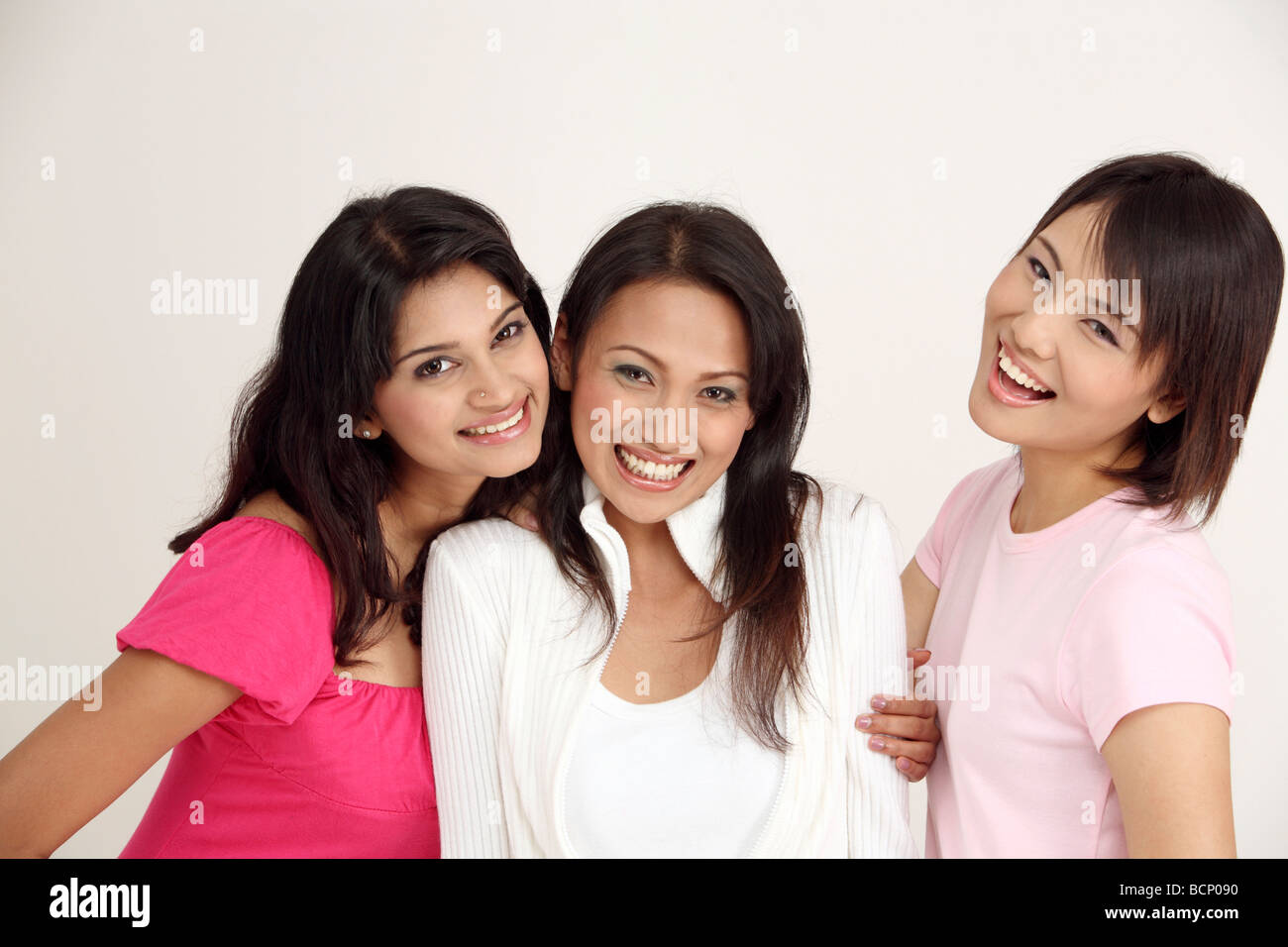 three friends happy and holding hands together Stock Photo - Alamy