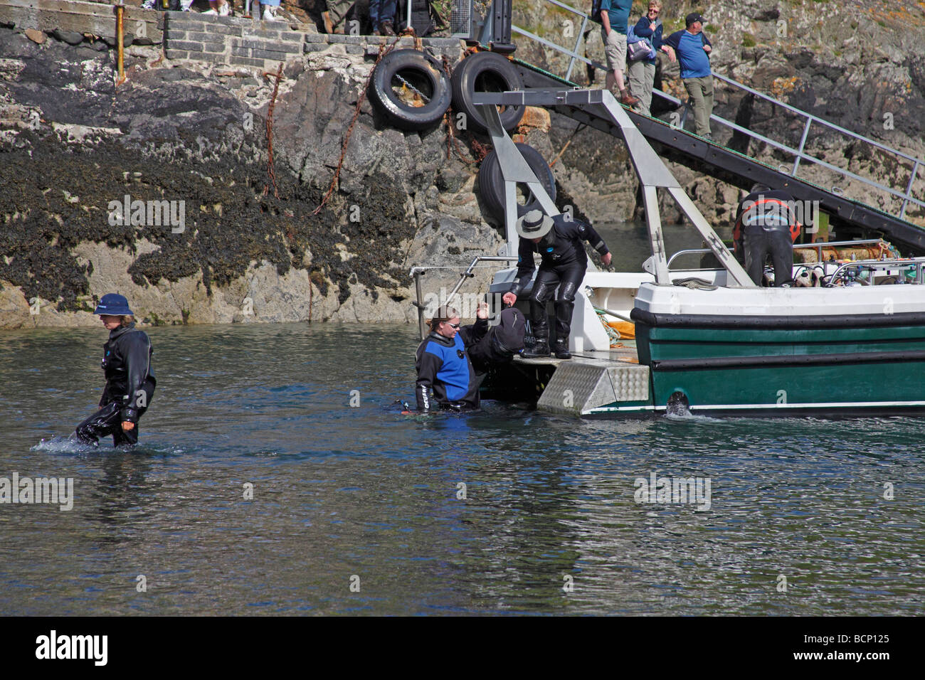 divers loading diving equipment onto boat in Cardigan bay West Wales ...