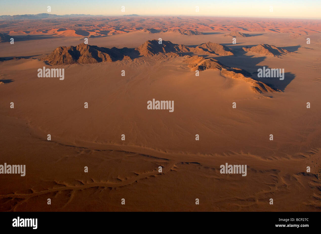 Aerial view of dried up river bed and Sossusvlei sand dunes that push ...