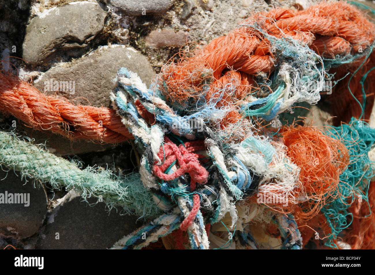 detail of a bundle of tangled ropes washed up on rocky beach Stock ...