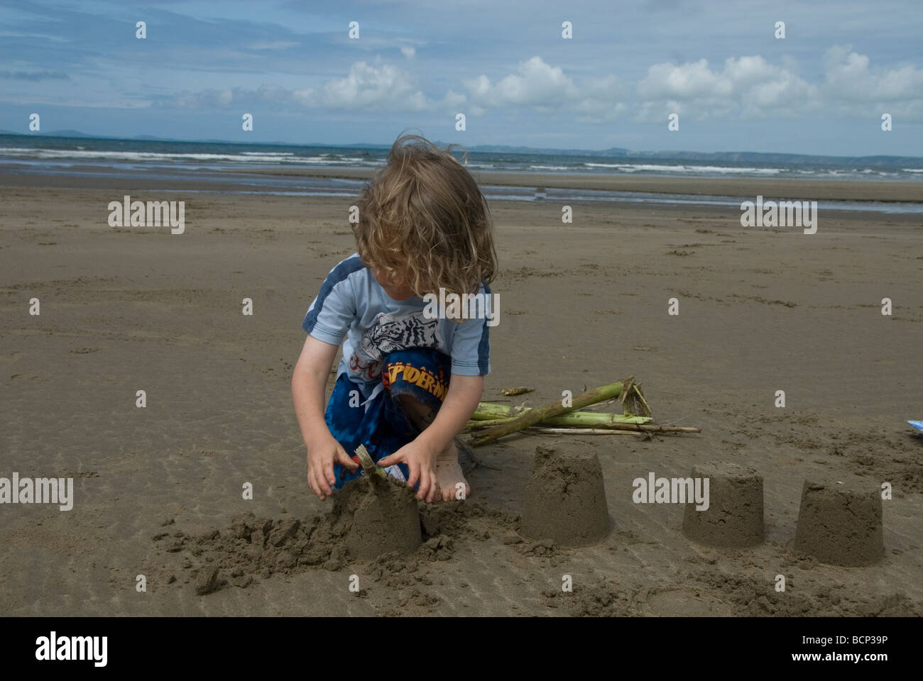 Child making sandcastles hi-res stock photography and images - Alamy