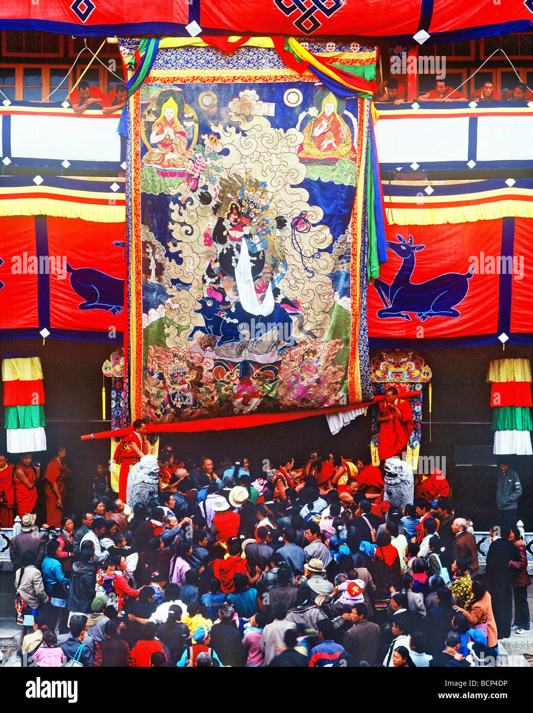 Pilgrims praying under the unveiled giant Tangka of Yama the Lord of ...