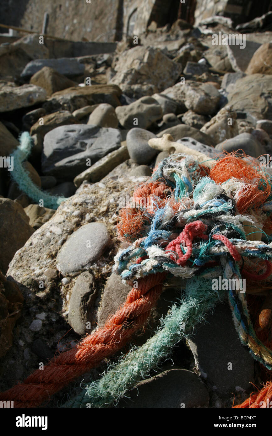 detail of a bundle of tangled ropes washed up on rocky beach Stock ...