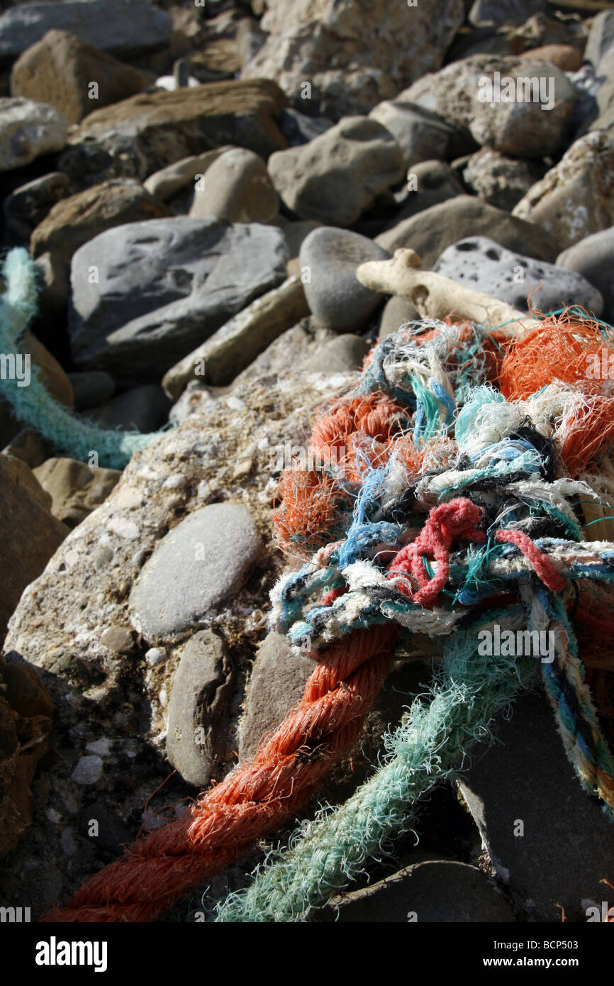 detail of a bundle of tangled ropes washed up on rocky beach Stock ...