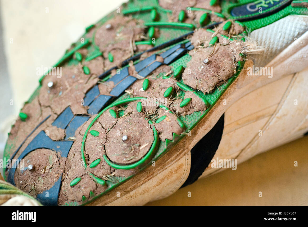 Cricket boots with studs and mud Stock Photo - Alamy