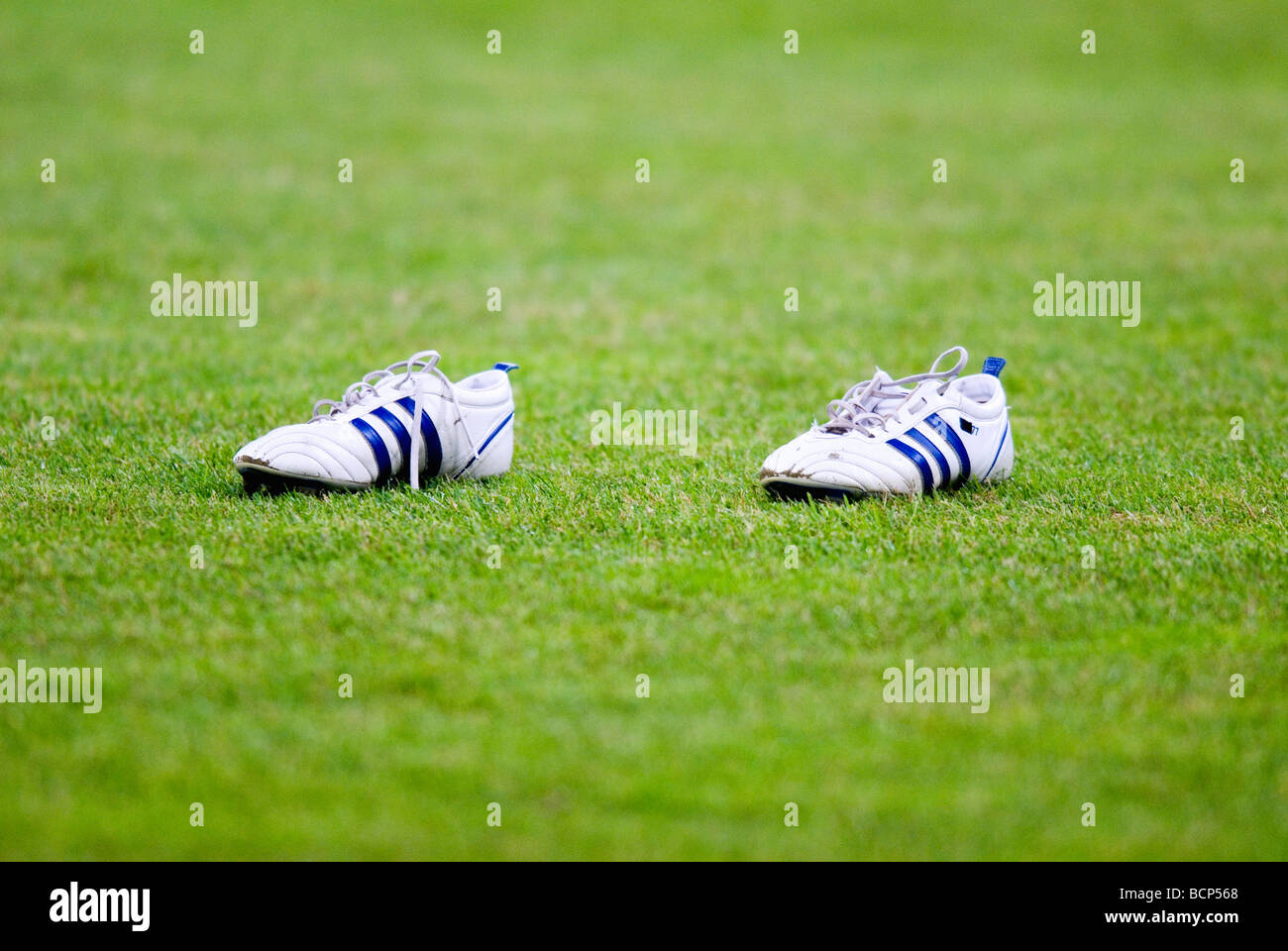 A pair of adidas soccer shoes on the field Stock Photo - Alamy