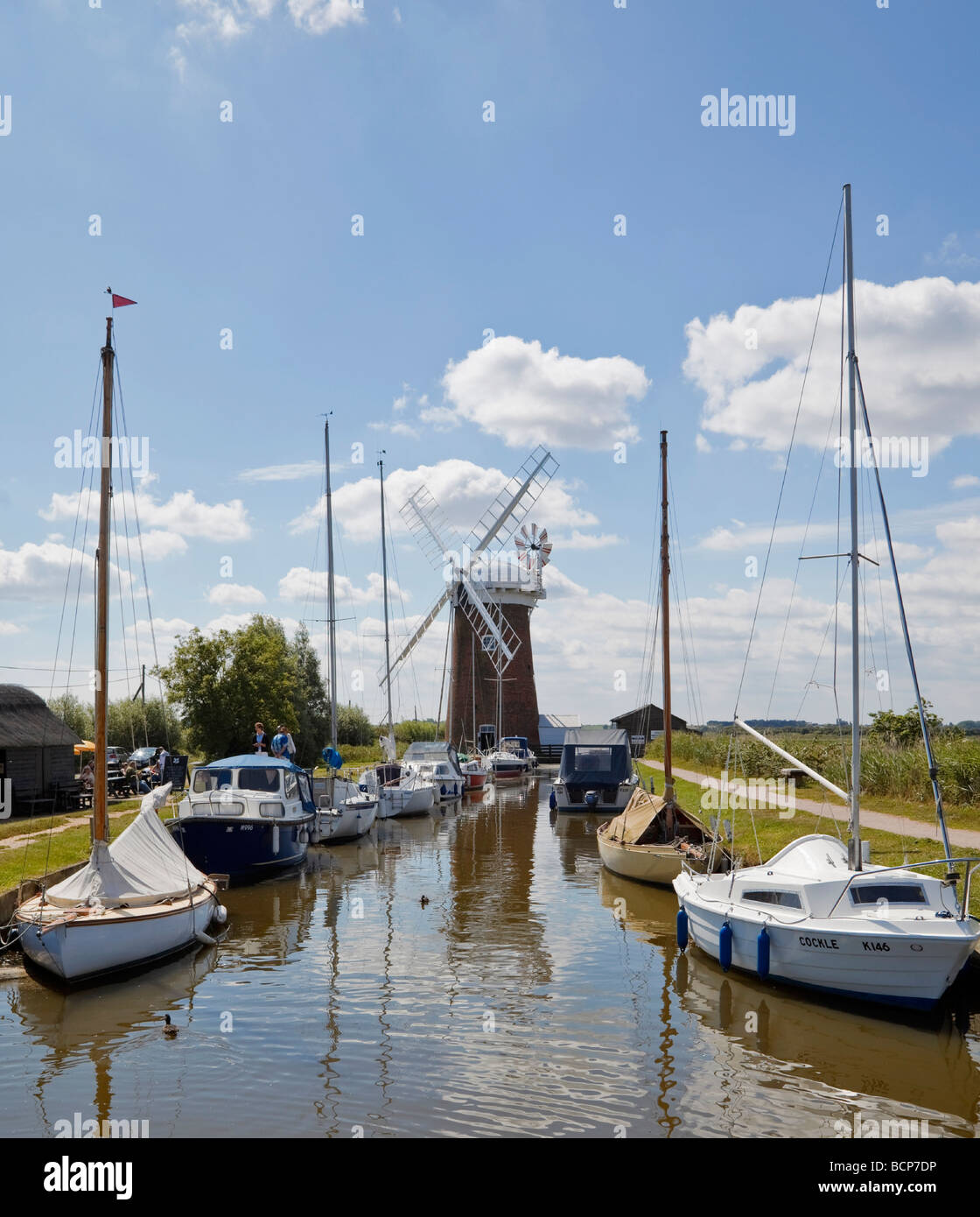 boats moored at horsey with the water mill in the background Stock ...