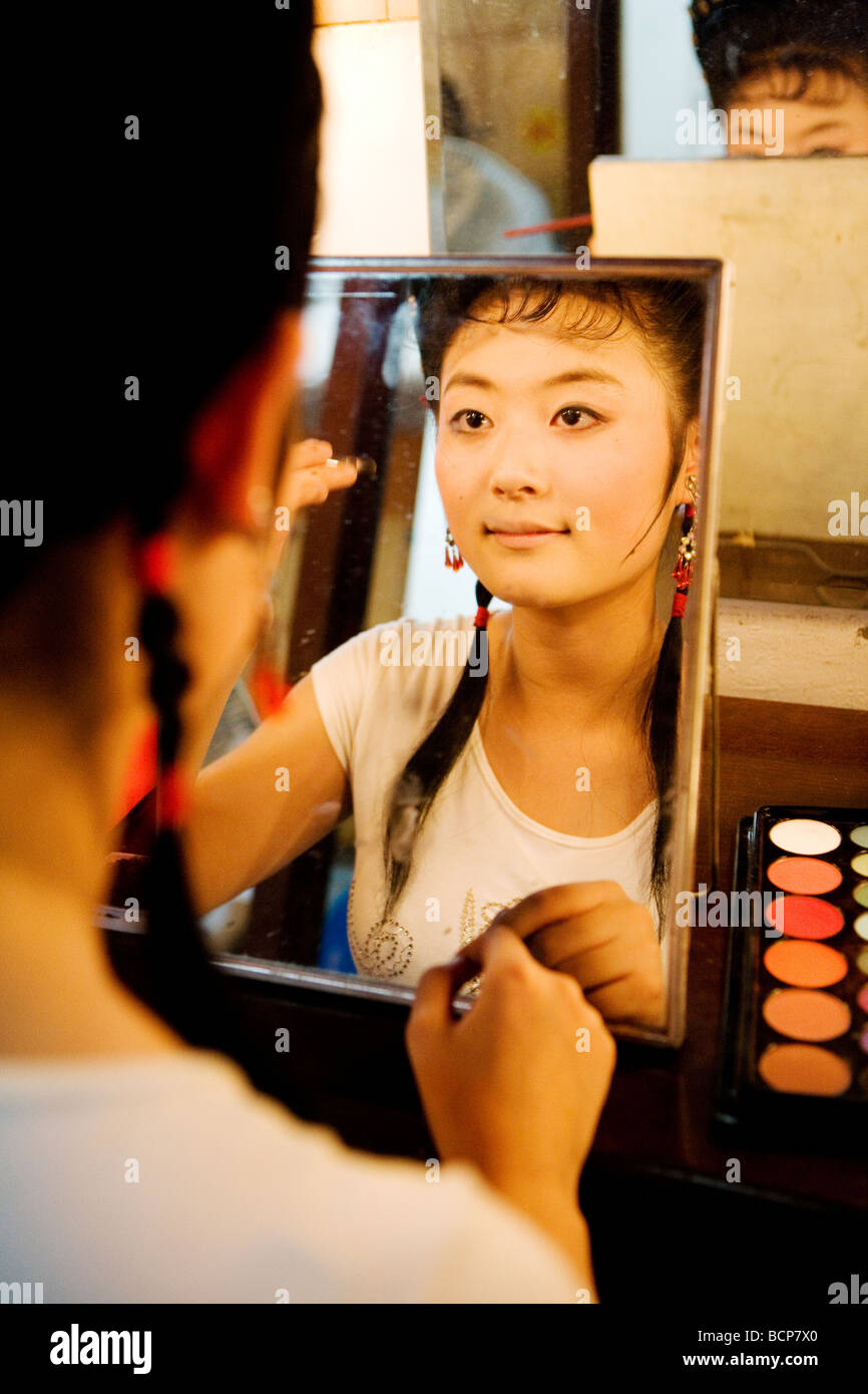 A Huangmei opera actress putting makeup on before performance, Anhui ...