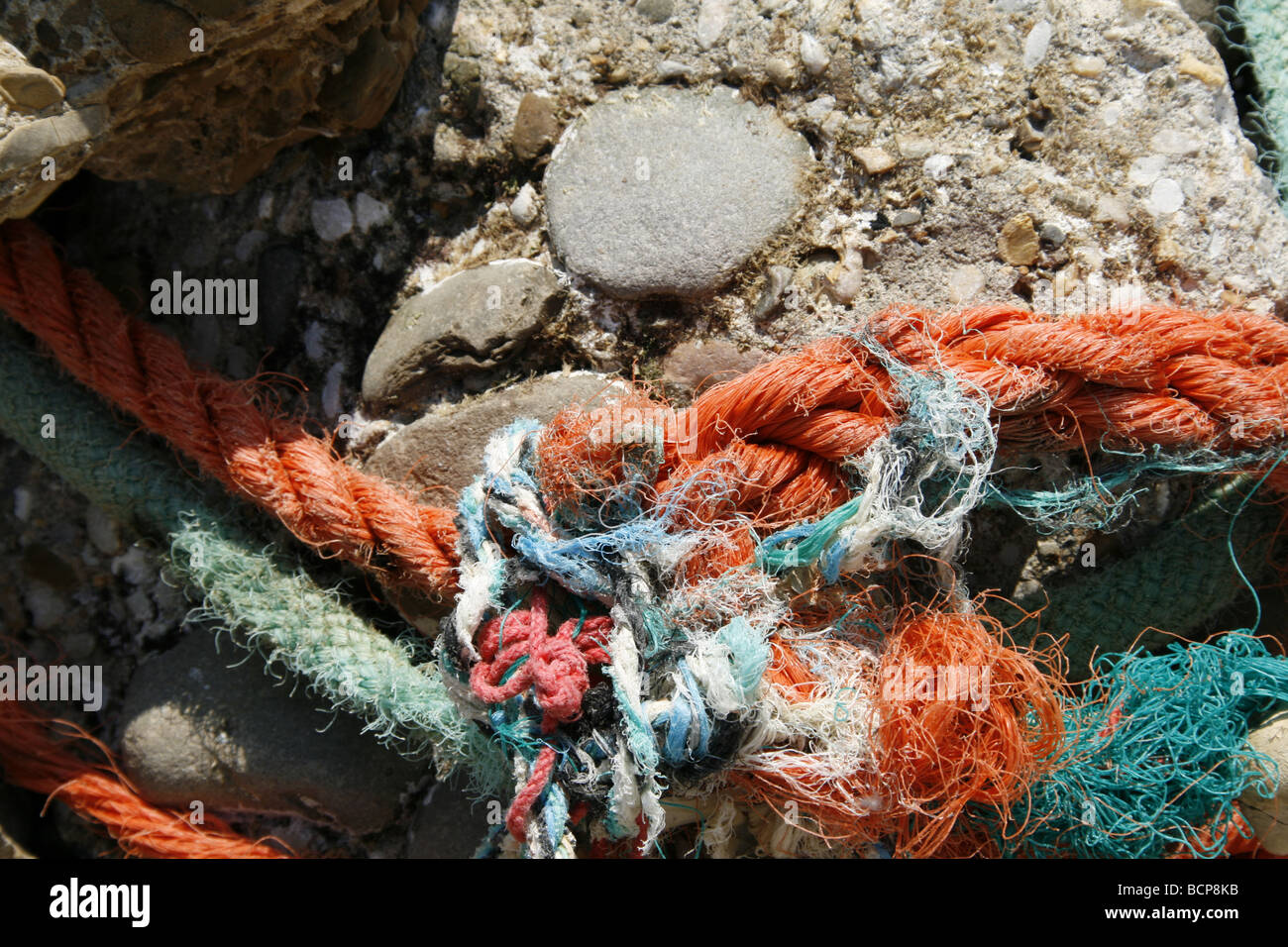 detail of a bundle of tangled ropes washed up on rocky beach Stock ...