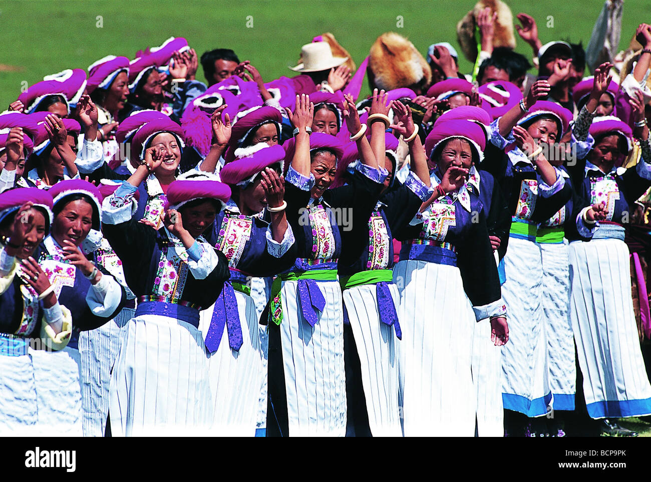 Tibeta women wearing bright pink head turban gathering for ceremony ...
