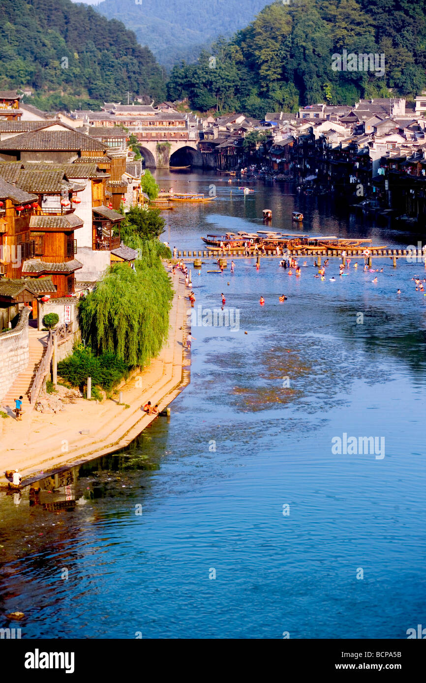 Tourists enjoying a swim in the Tuo River, Fenghuang Ancient Town ...