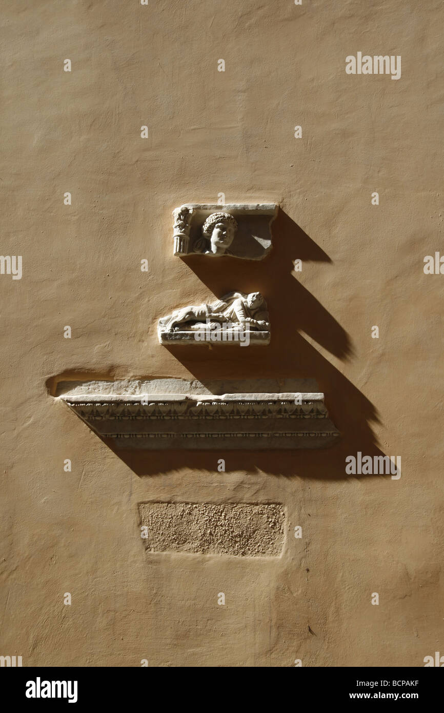 ancient roman relics on property wall near via del corso street in rome ...